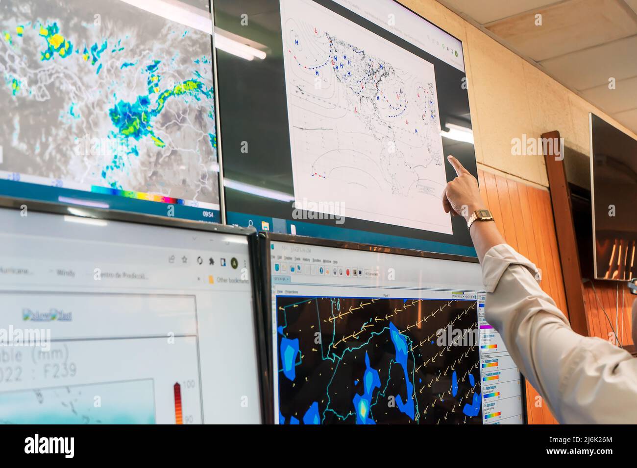 Weather prediction by an unrecognizable scientist pointing at the ...