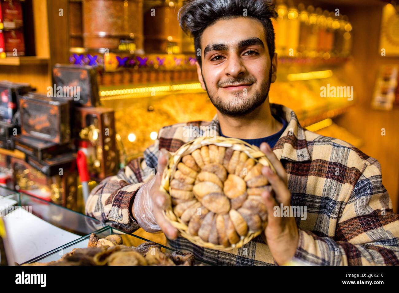 Turkish seller man in the bazaar serving customers with Turkey products ...