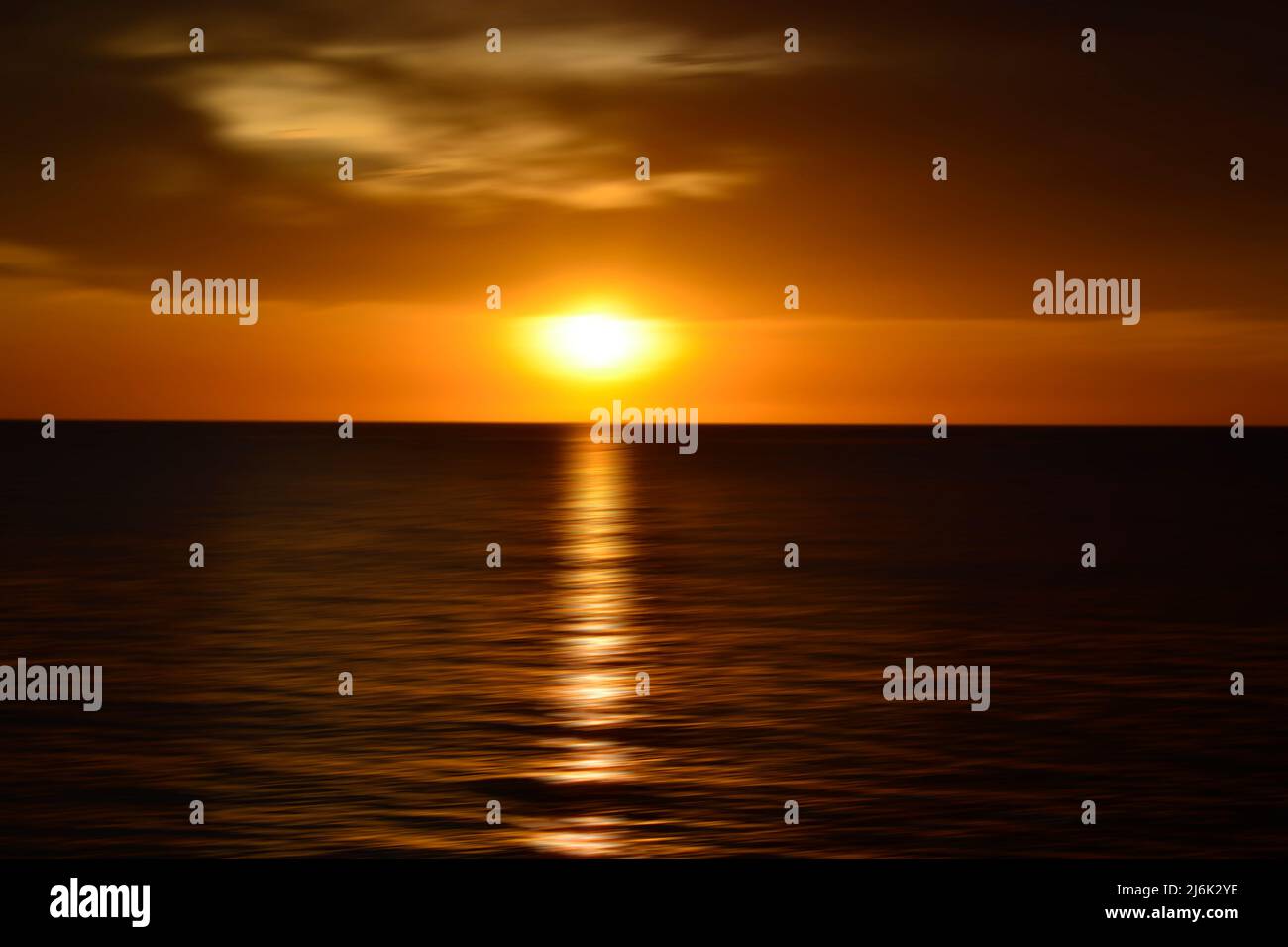 Sunset over the ocean. Blurry ocean landscape background and sunset ...