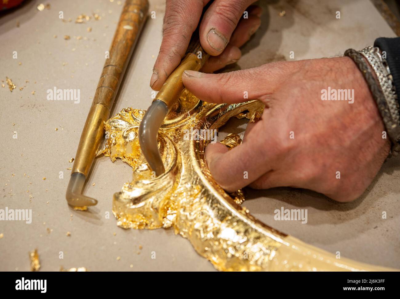 Gilded frame ready for burnishing with an agate stone tool. Gilding ...