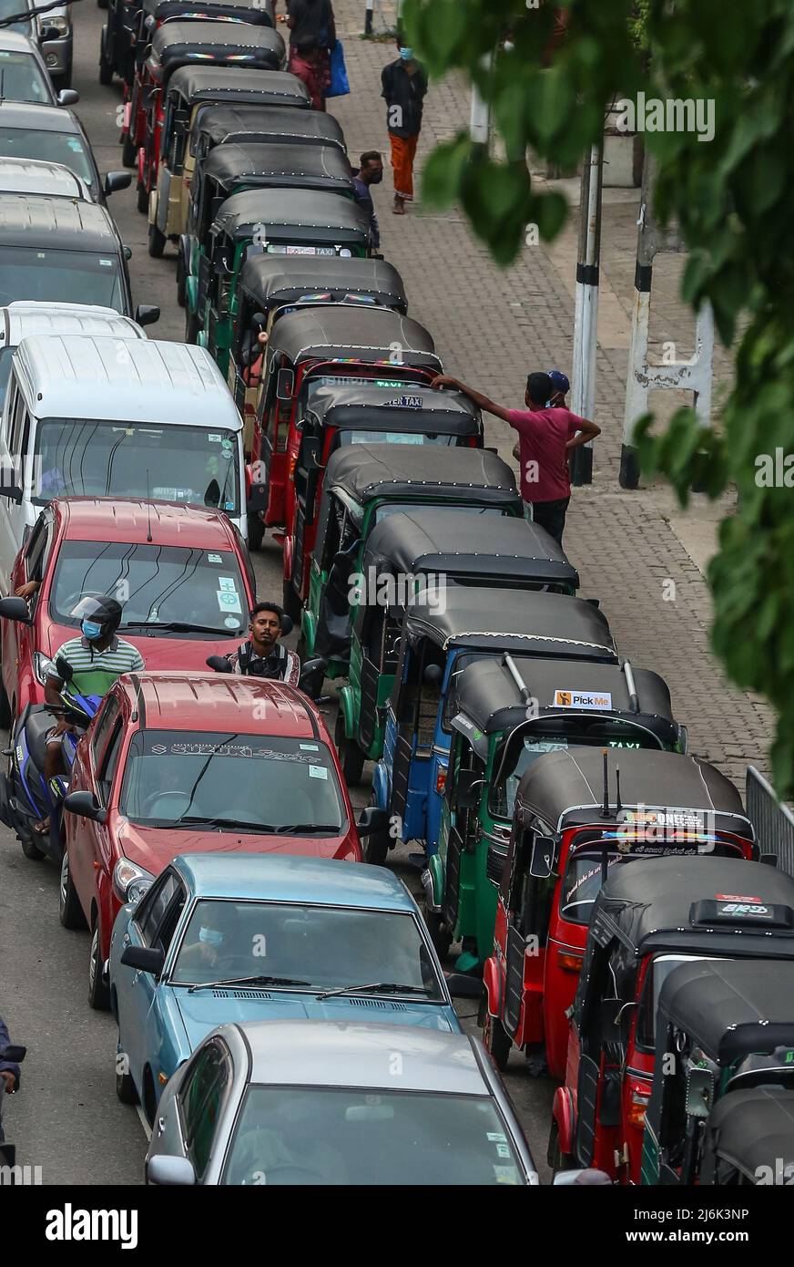 Vehicles queue up to use the fuel pumps at a fuel station in Colombo ...