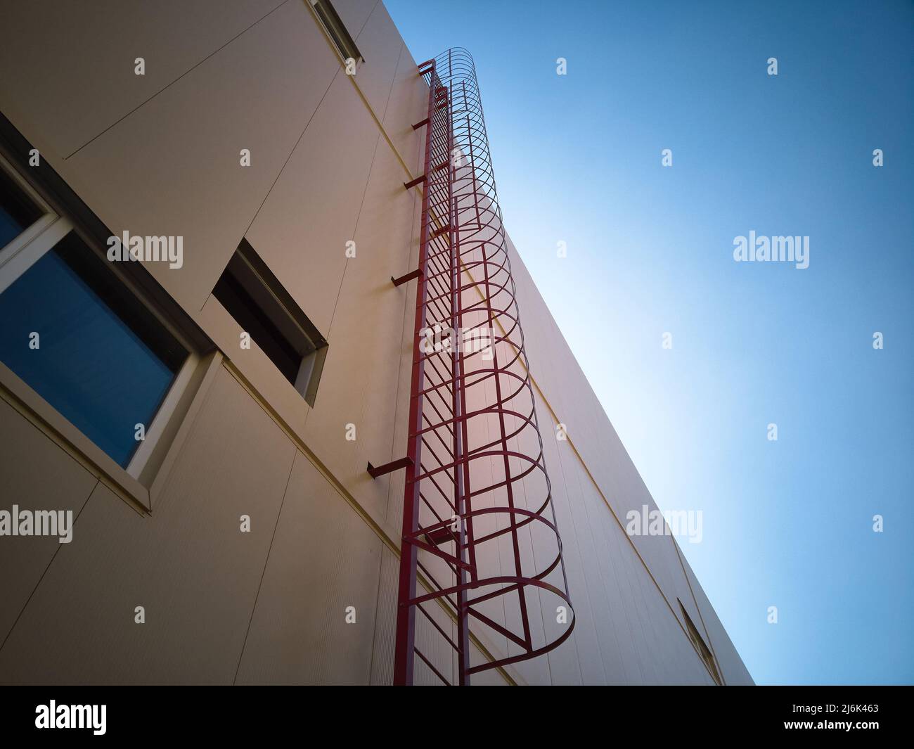 Outdoor fire escape ladder on industrial building wall Stock Photo - Alamy