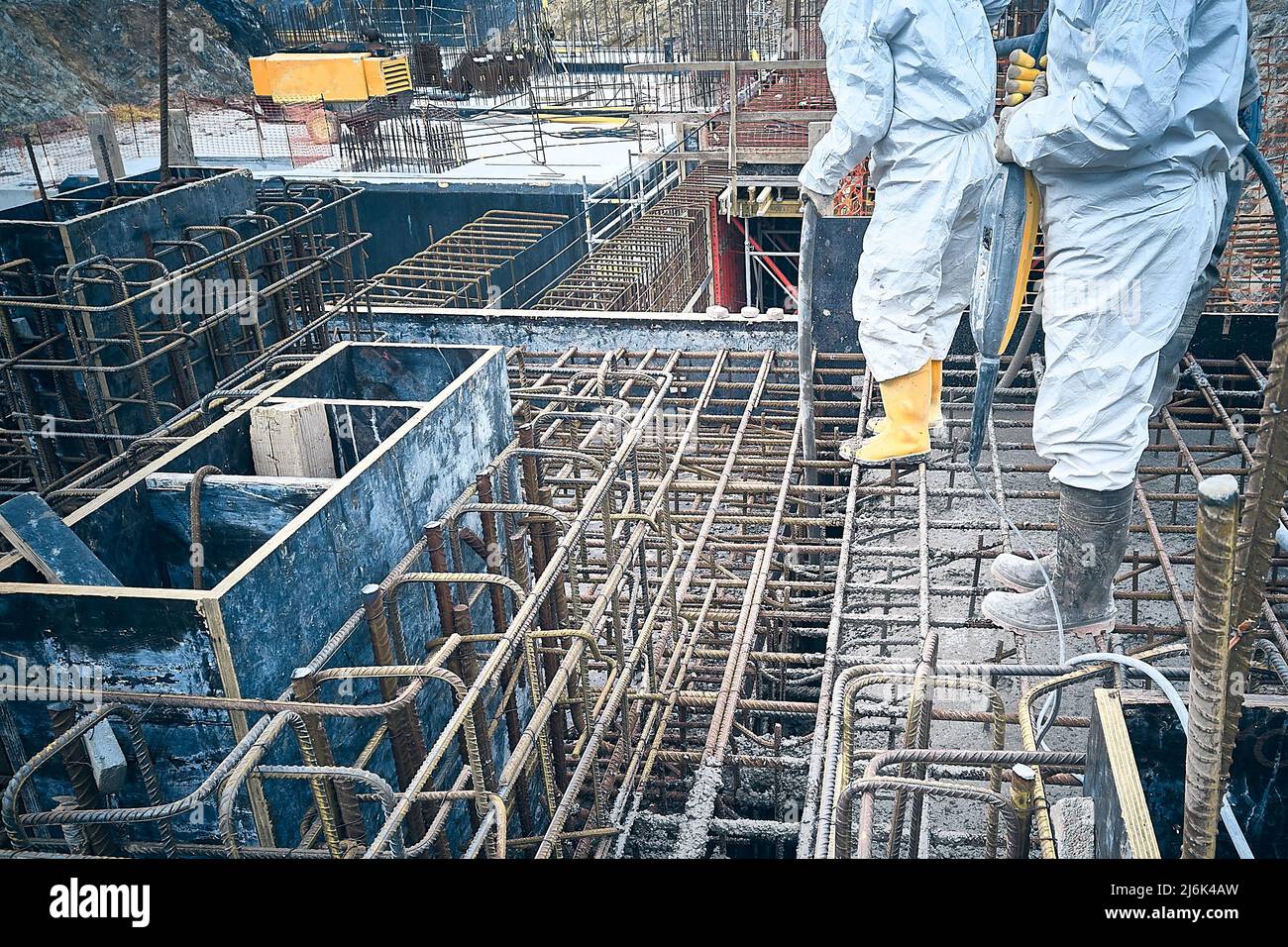 Workers compact concrete Stock Photo - Alamy