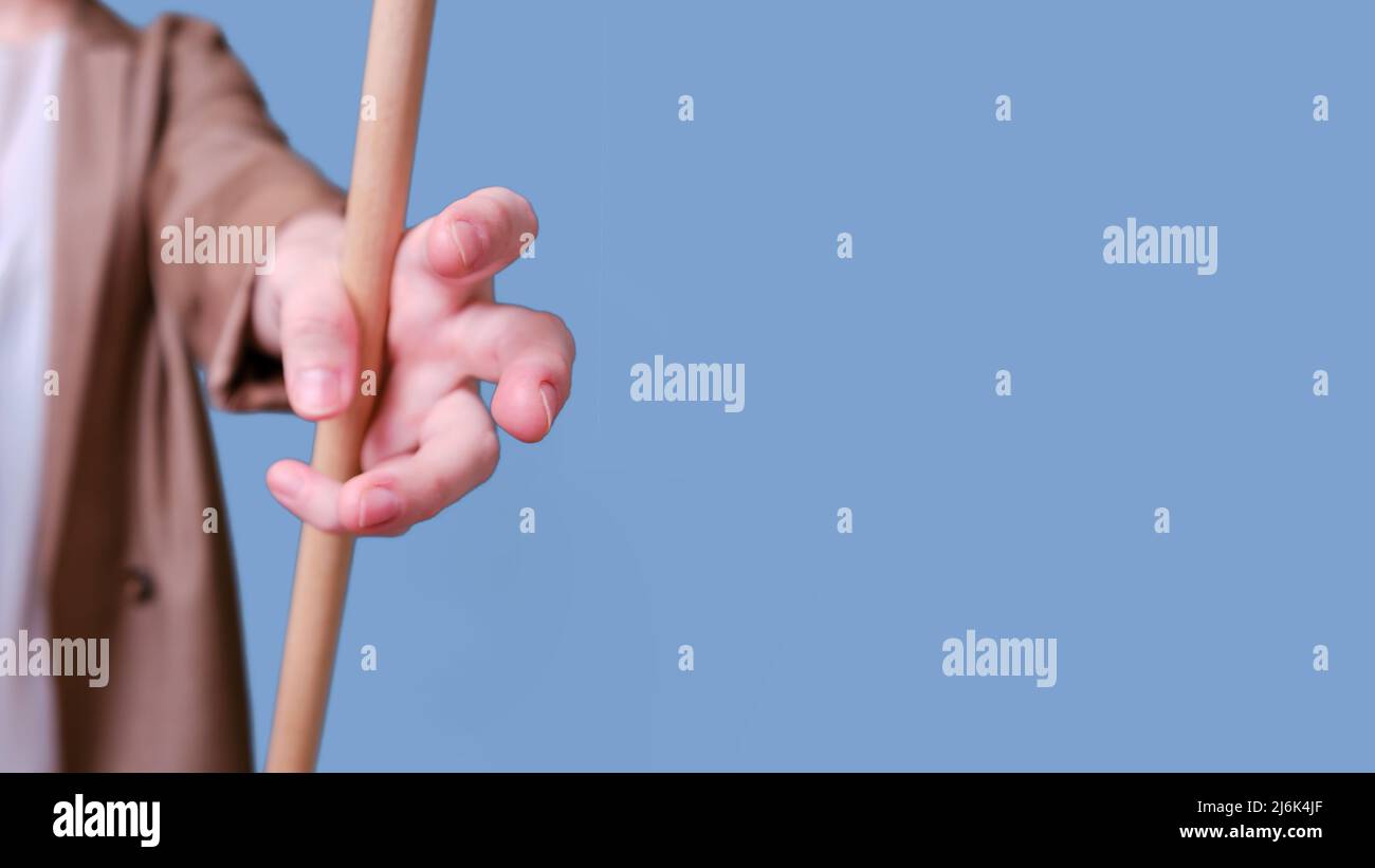 Woman teacher pulls her hands forward and wants to grab on studio blue ...