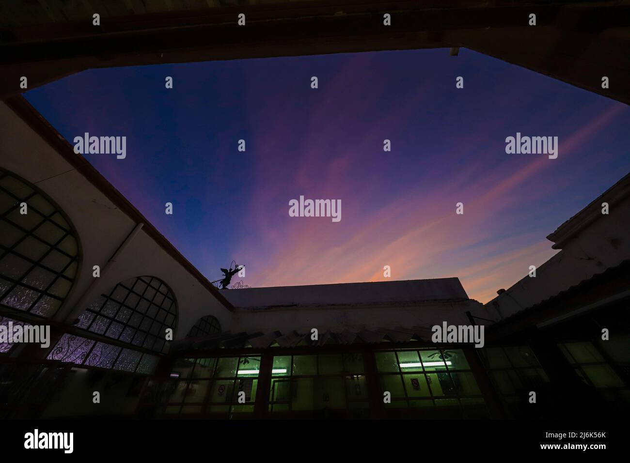 Purple and pink colored sky at dusk seen on the patio and roof of the ...