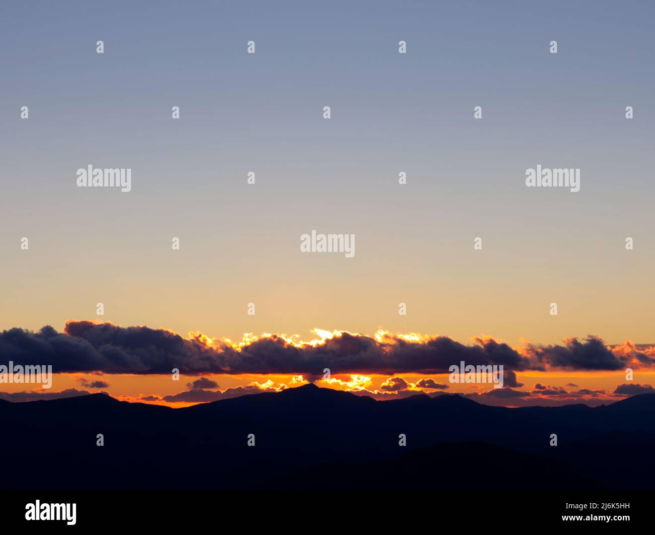 Mountain ridge at sunset with clouds Stock Photo - Alamy