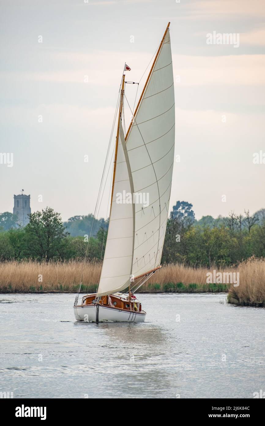 Traditional wooden sailboat sailing along the River Bure, Norfolk ...