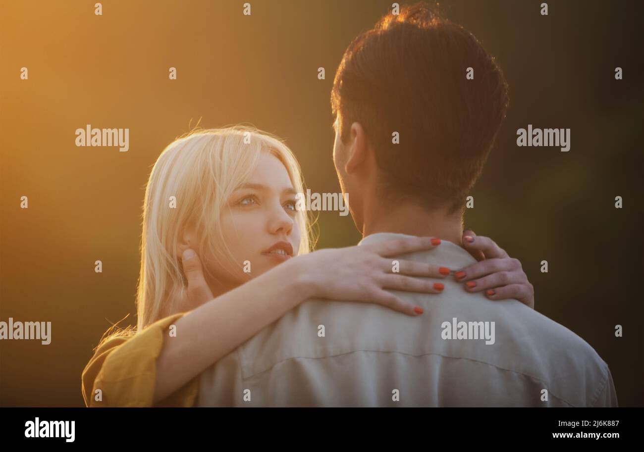 Sensual portrait of young couple in love. Couple lovers hugging and kissing at sunset. Loving ...