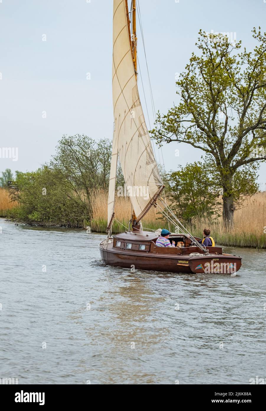 Traditional wooden sailboat sailing along the River Bure, Norfolk ...