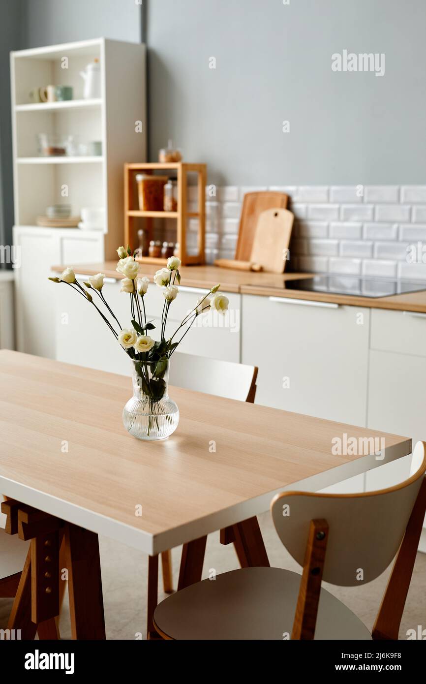 Vertical background image of fresh white flowers on dinner table in ...