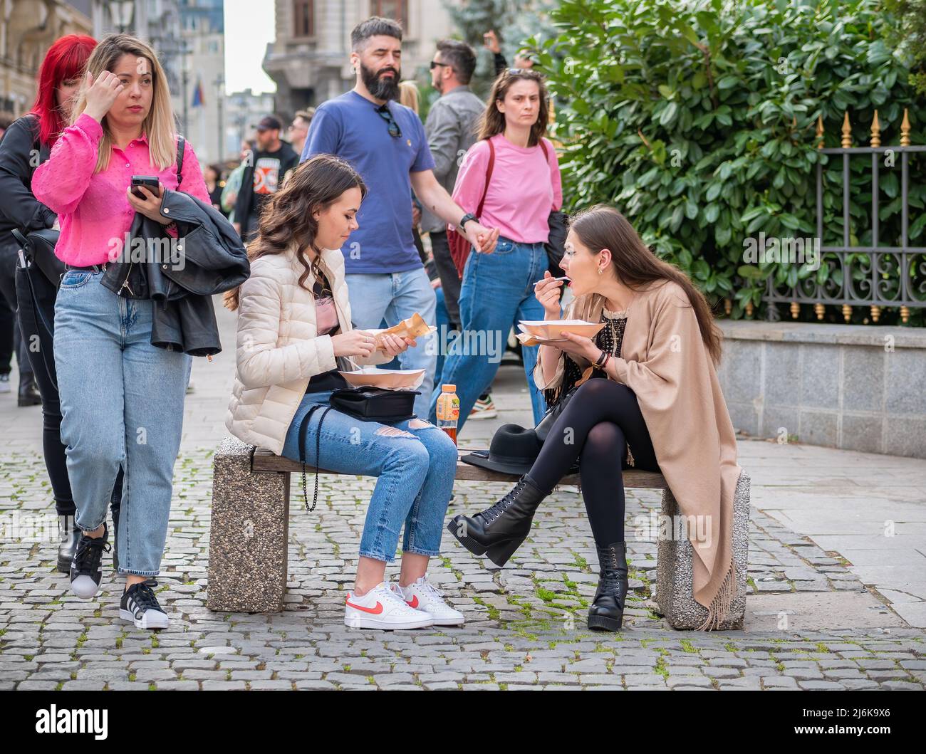 Bucharest, Romania - 04.08.2022: Two beautiful young girls sitting on a ...