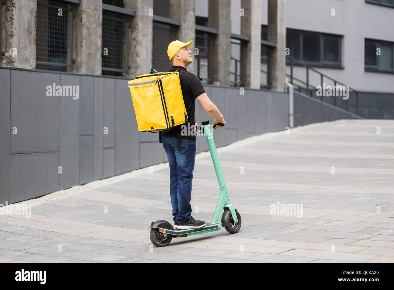 Delivery man of takeaway on scooter with isothermal food case box ...
