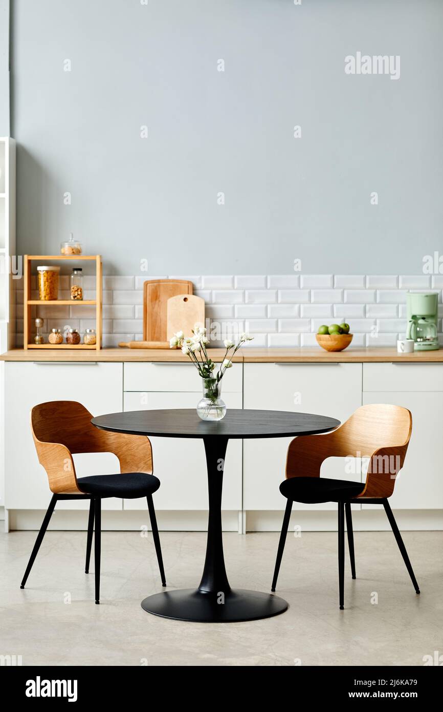 Minimal background image of elegant black table with two chairs in ...