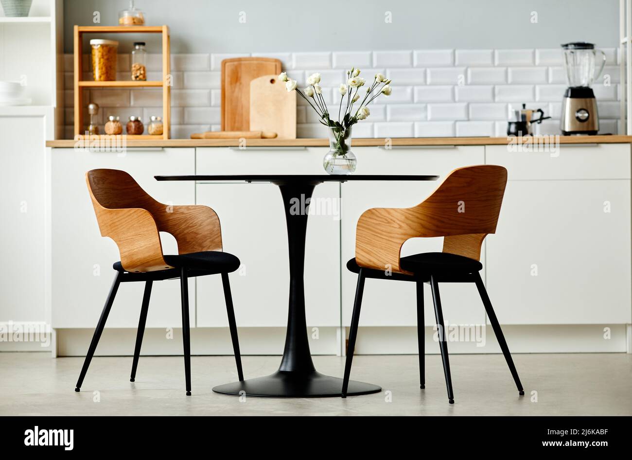 Minimal background image of black kitchen table set with two wooden ...