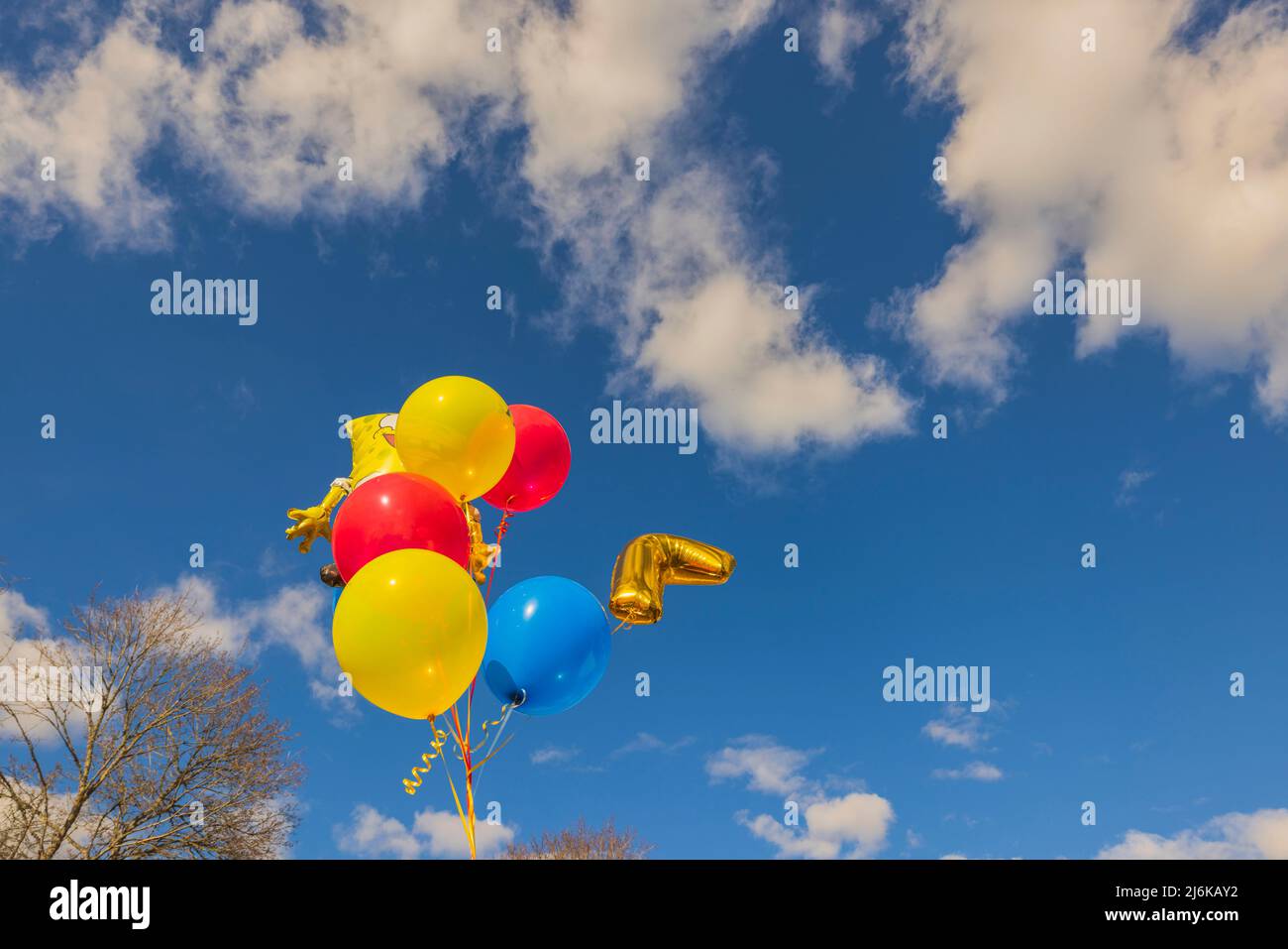Beautiful view of festive balloons for child developing in wind against ...