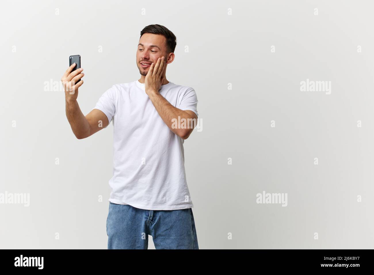 Cute happy tanned handsome man in basic t-shirt talk with family touch ...