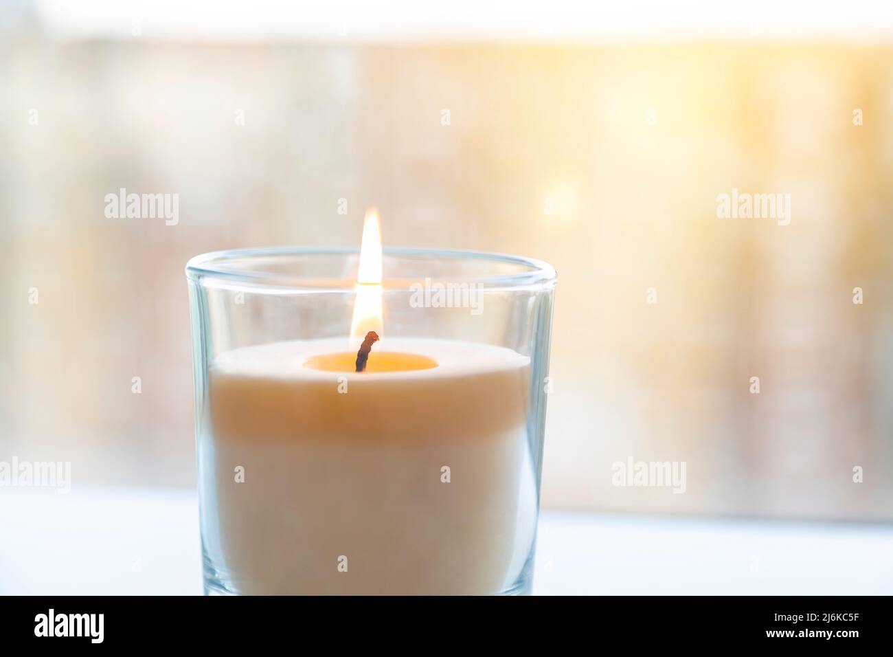 aroma candle that burns on a background of sunlight Stock Photo - Alamy