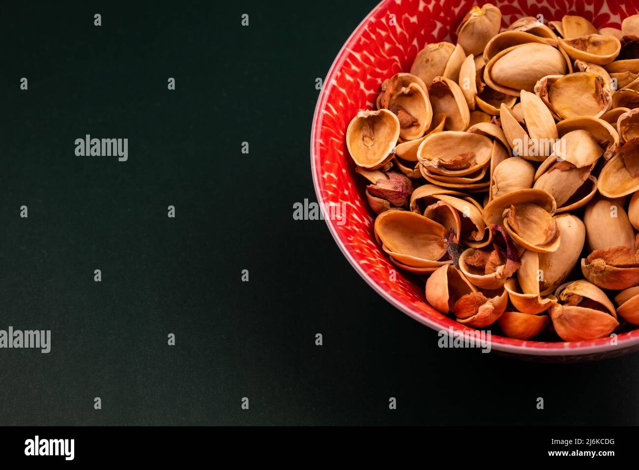 Organic Pistachio Shells in a Flowery Bowl on top of a Green Stock ...