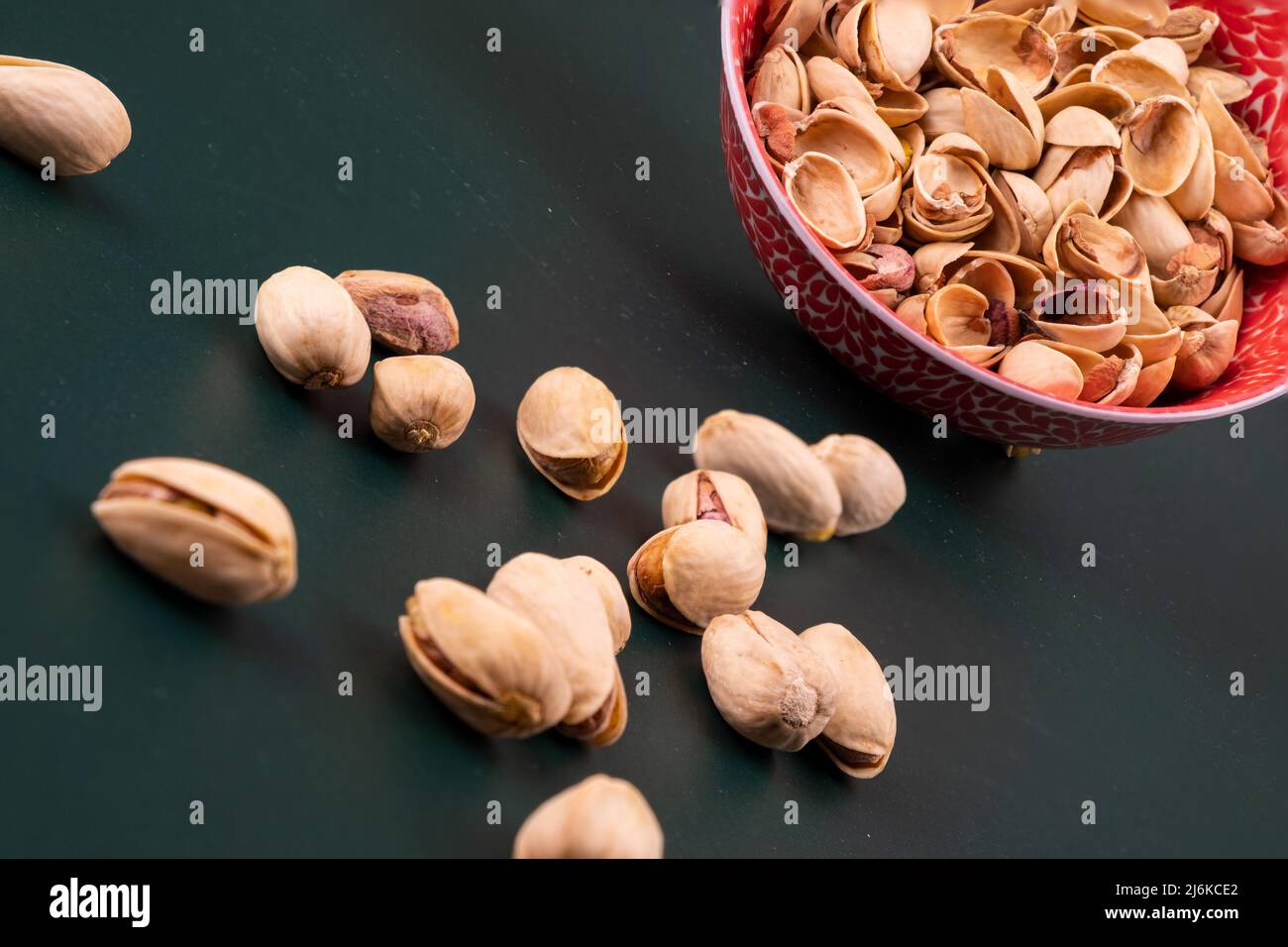 Organic Pistachio Shells in a Flowery Bowl on top of a Green Stock ...