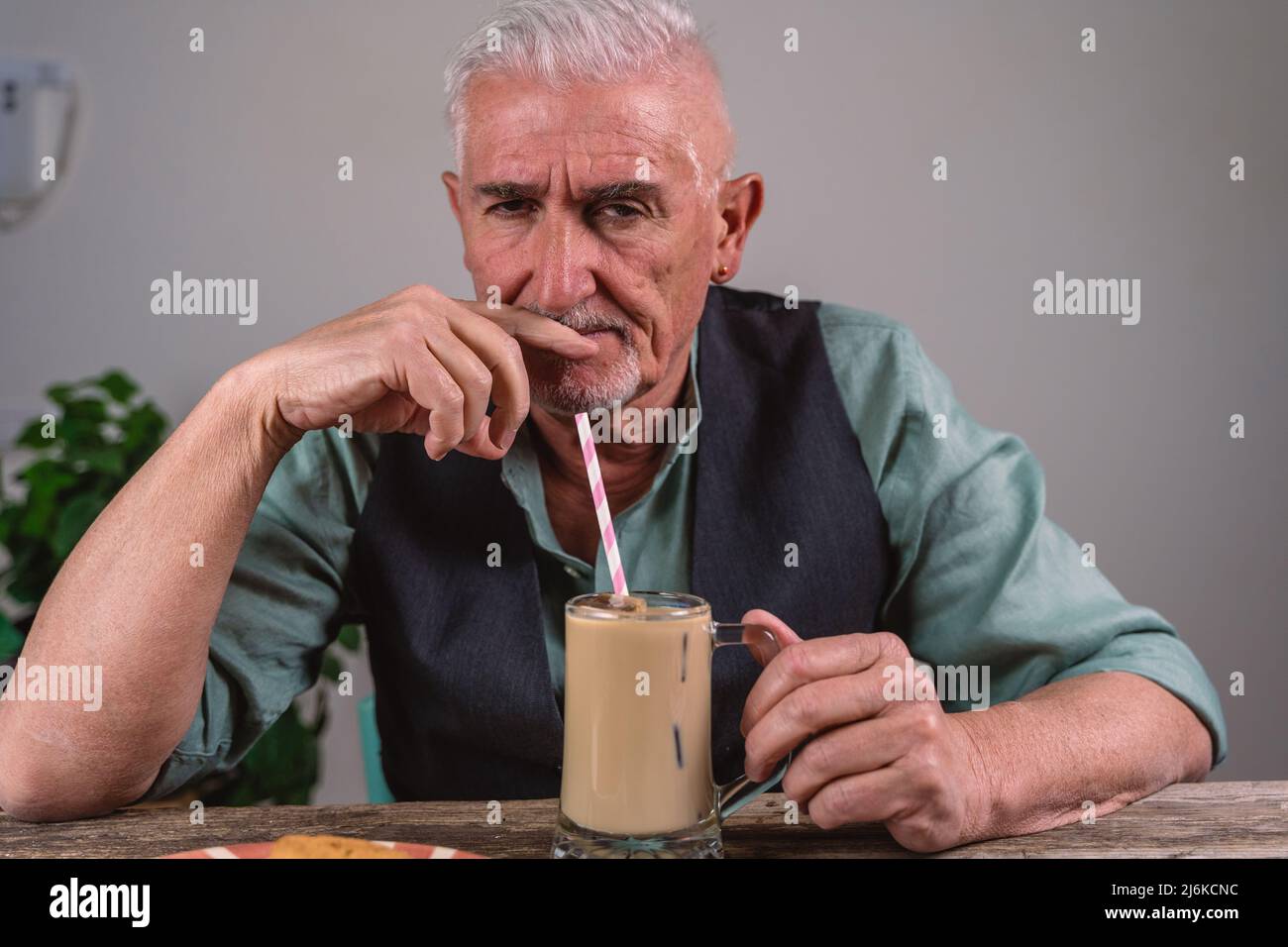 Man drink coffee through a straw hi-res stock photography and images ...