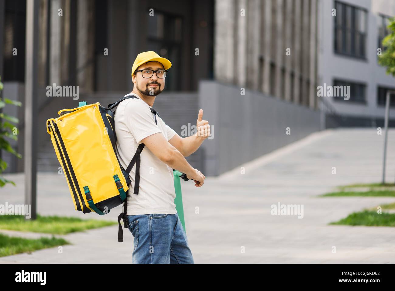 Delivery man of takeaway on scooter with isothermal food case box ...