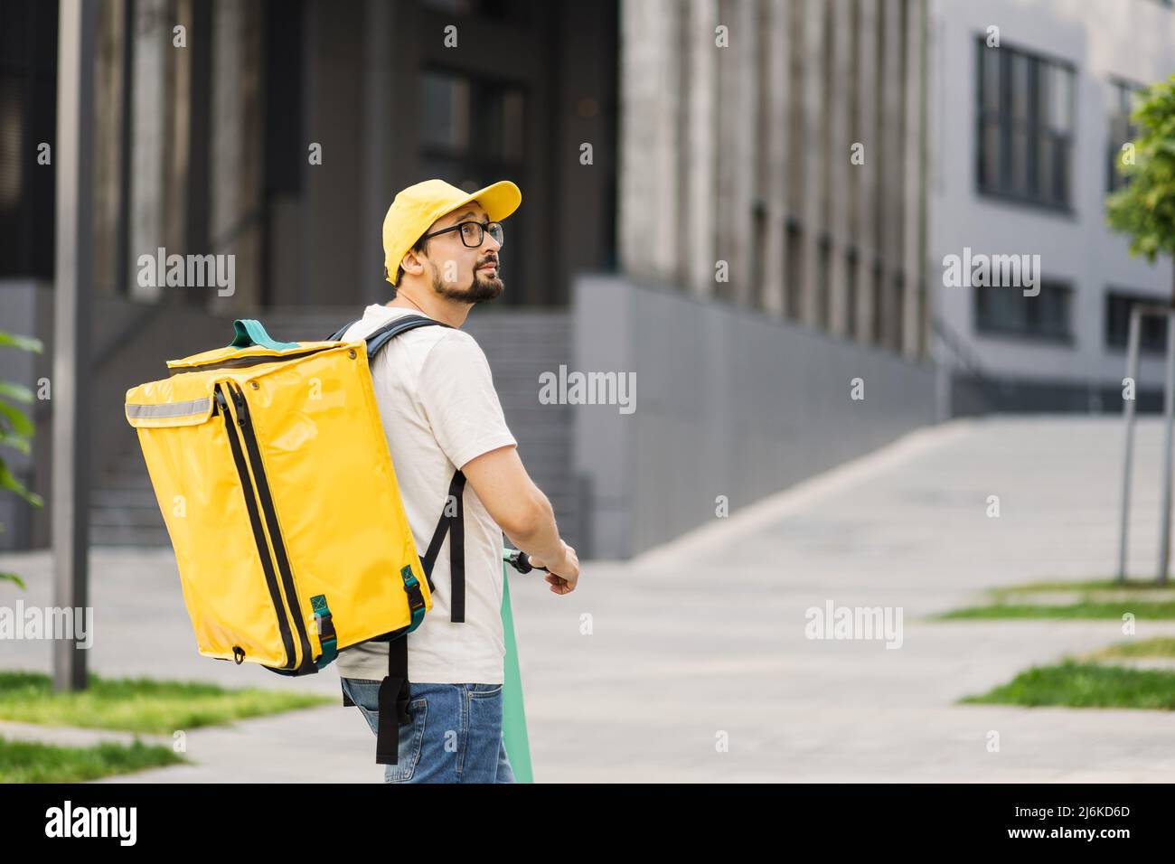 Delivery man of takeaway on scooter with isothermal food case box ...