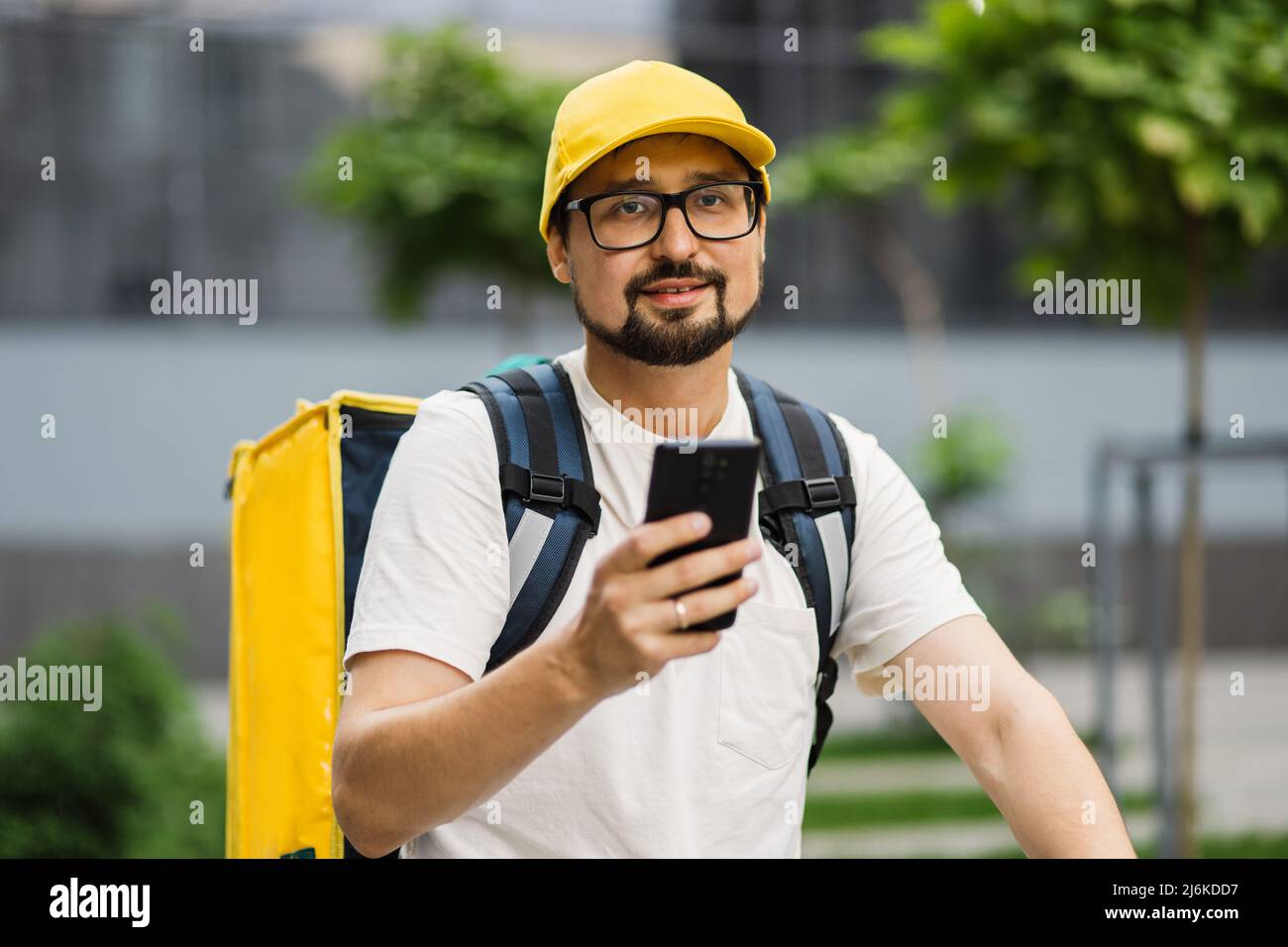 Delivery man with yellow backpack hi-res stock photography and images ...
