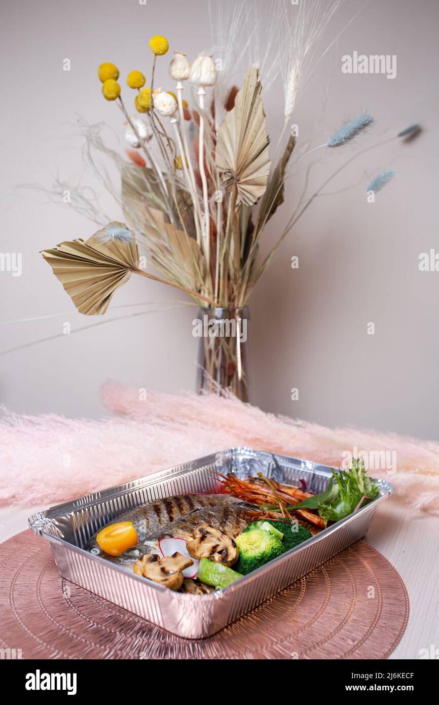 packaging for seafood delivery with fish, shrimp and vegetables on the ...