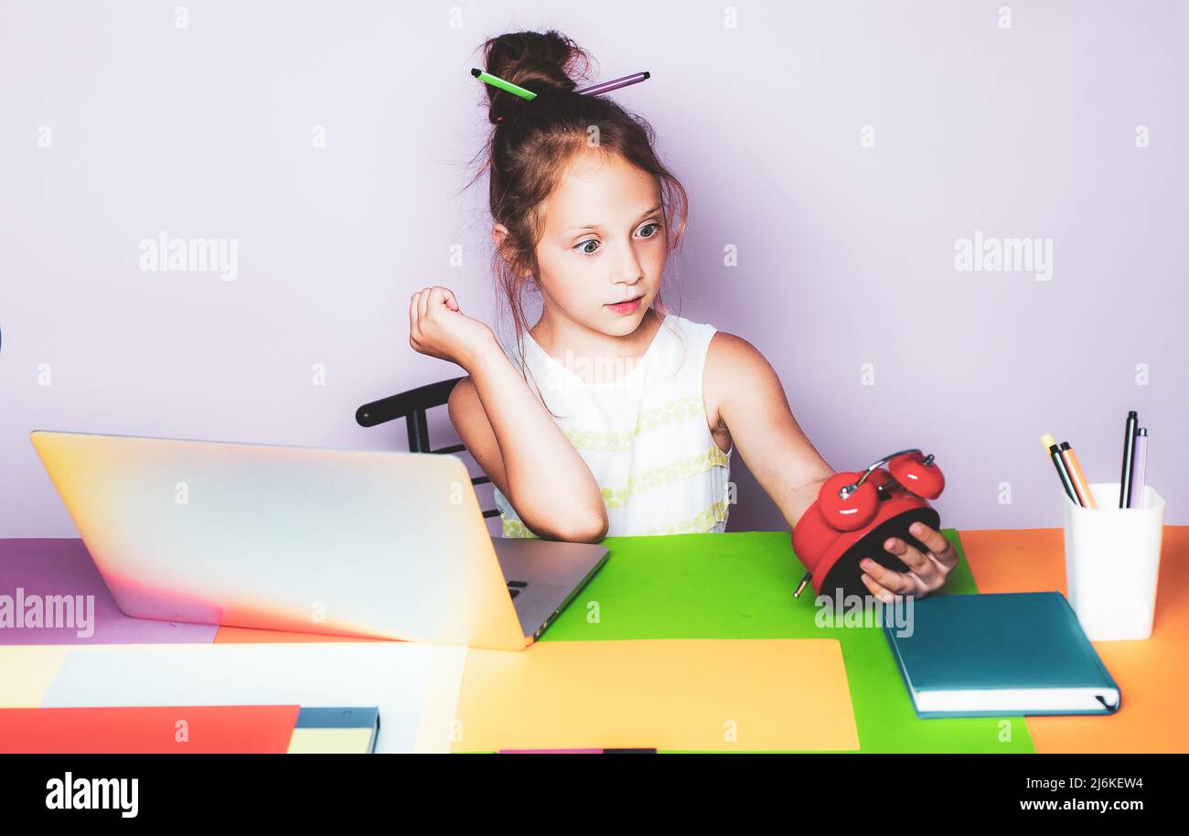 Schoolgirl studies at home and does school homework. Education and ...