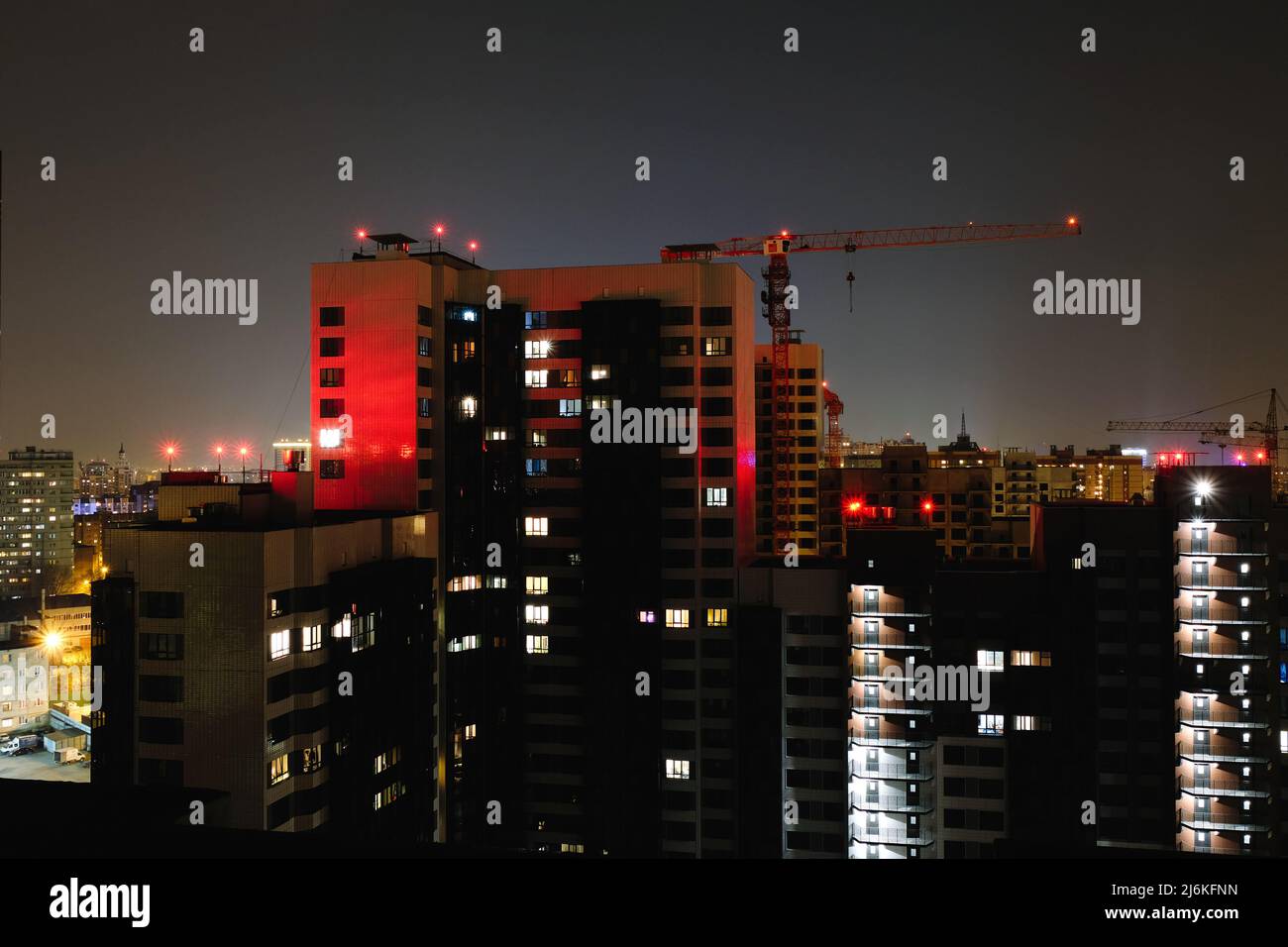 Construction of a high-rise modern panel building at night Stock Photo ...