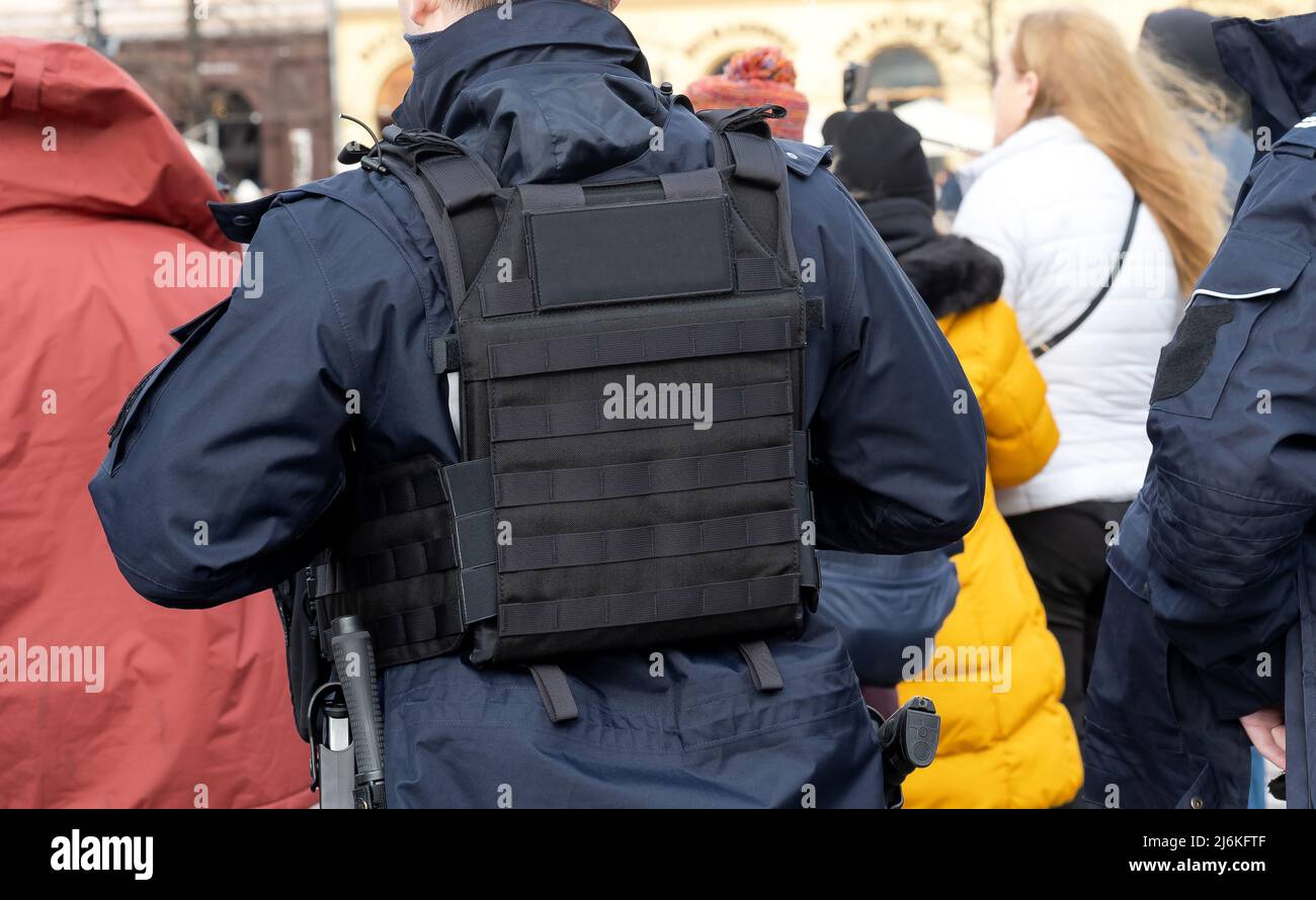 Anonymous police officer in a generic bulletproof vest, back, blue ...