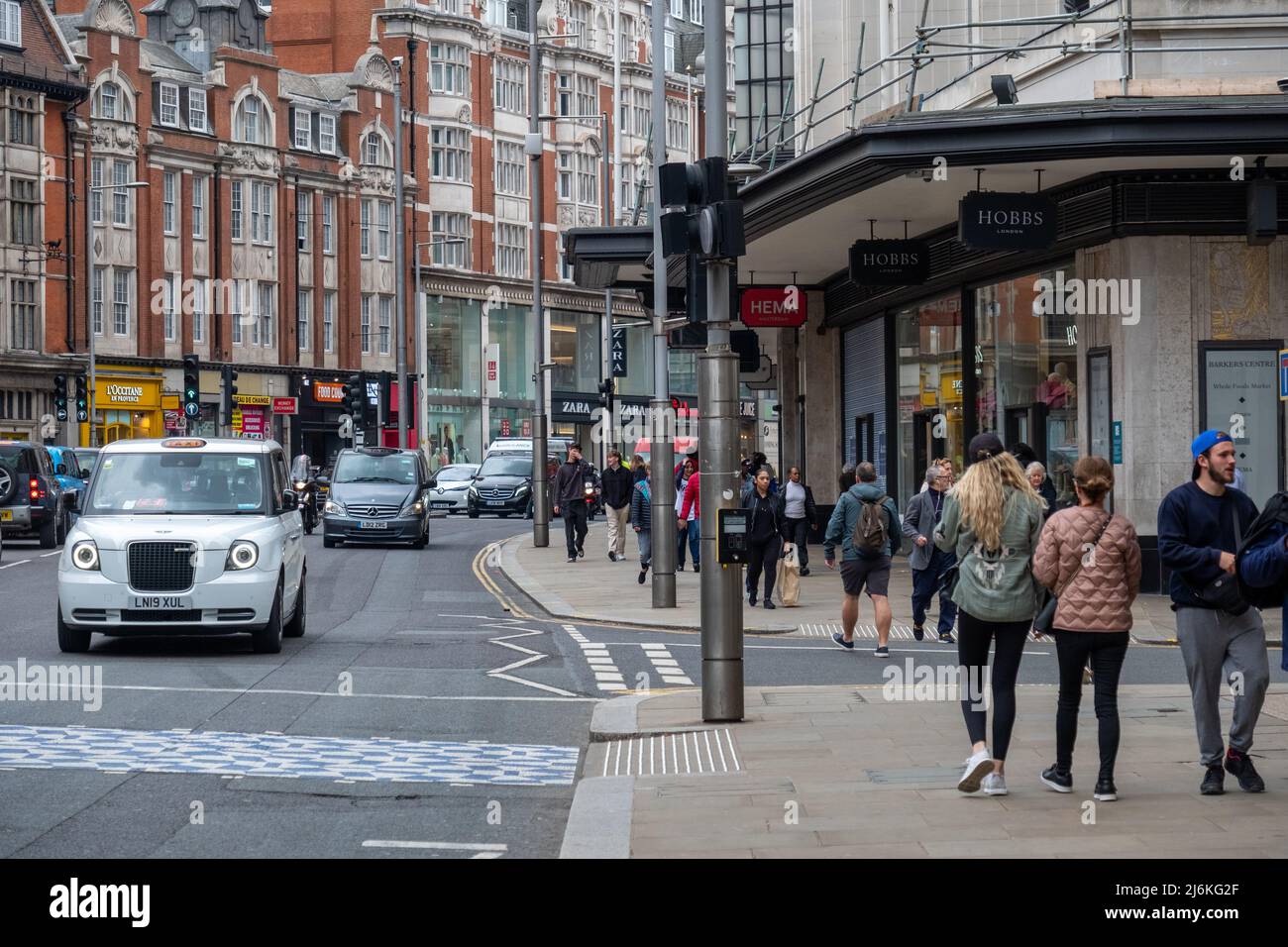 London, April 2022: Busy street scene with shoppers walking on ...