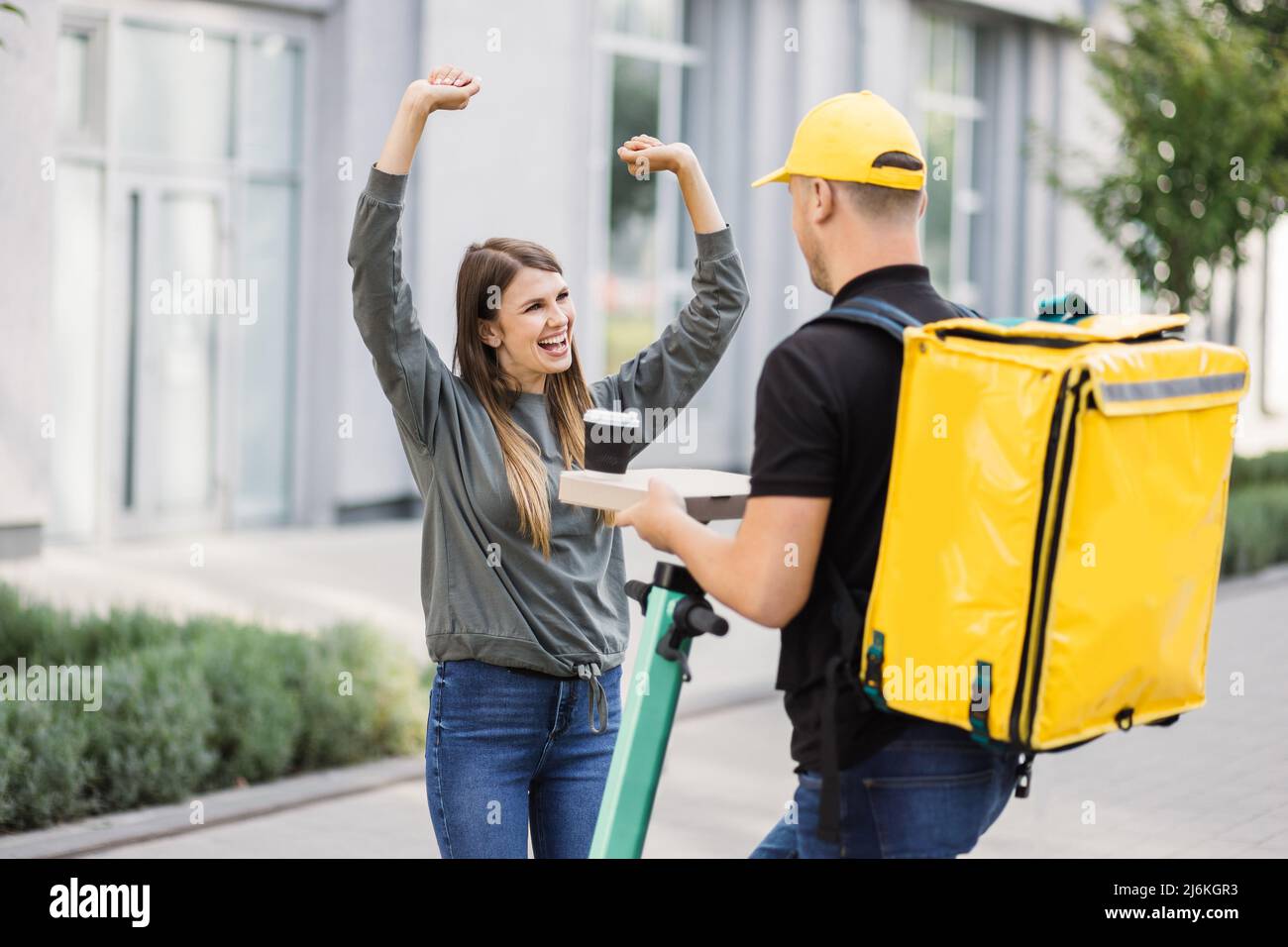 Delivery man giving pizza to happy customer. Food delivery courier ...