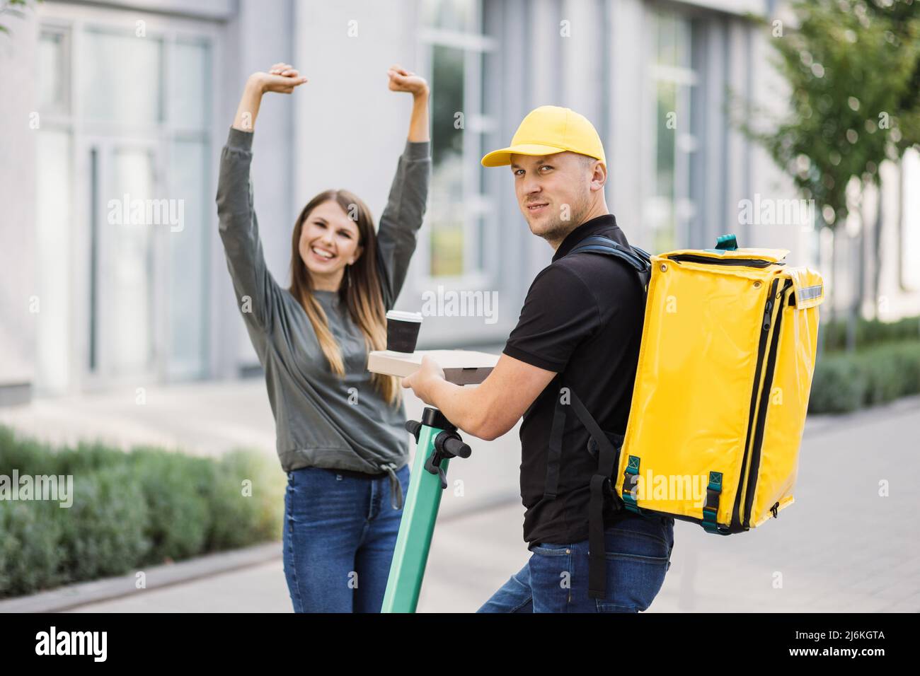 Delivery man giving pizza to happy customer. Food delivery courier ...