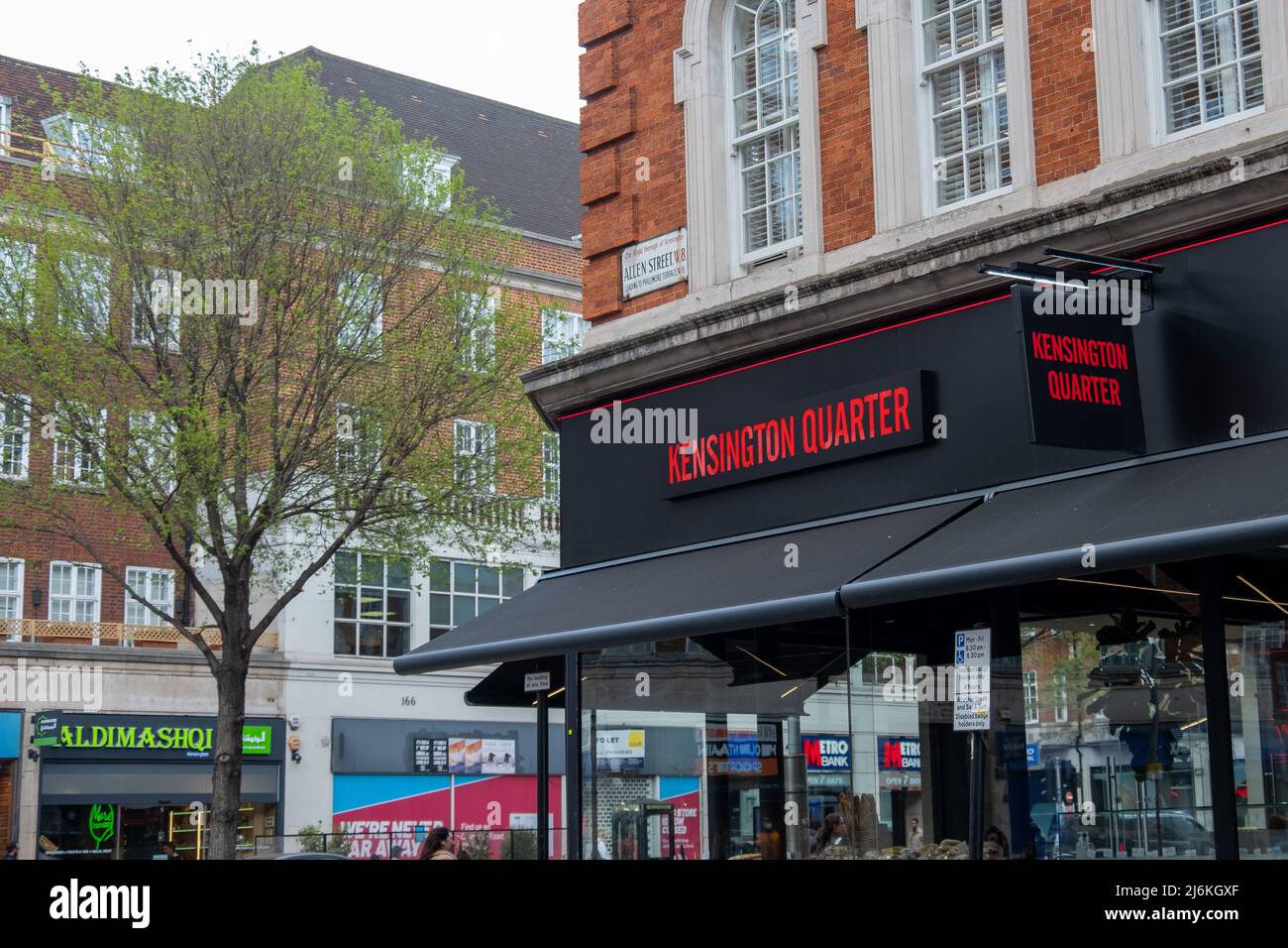 London, April 2022: Shops and restaurants on High street Kensington, a ...