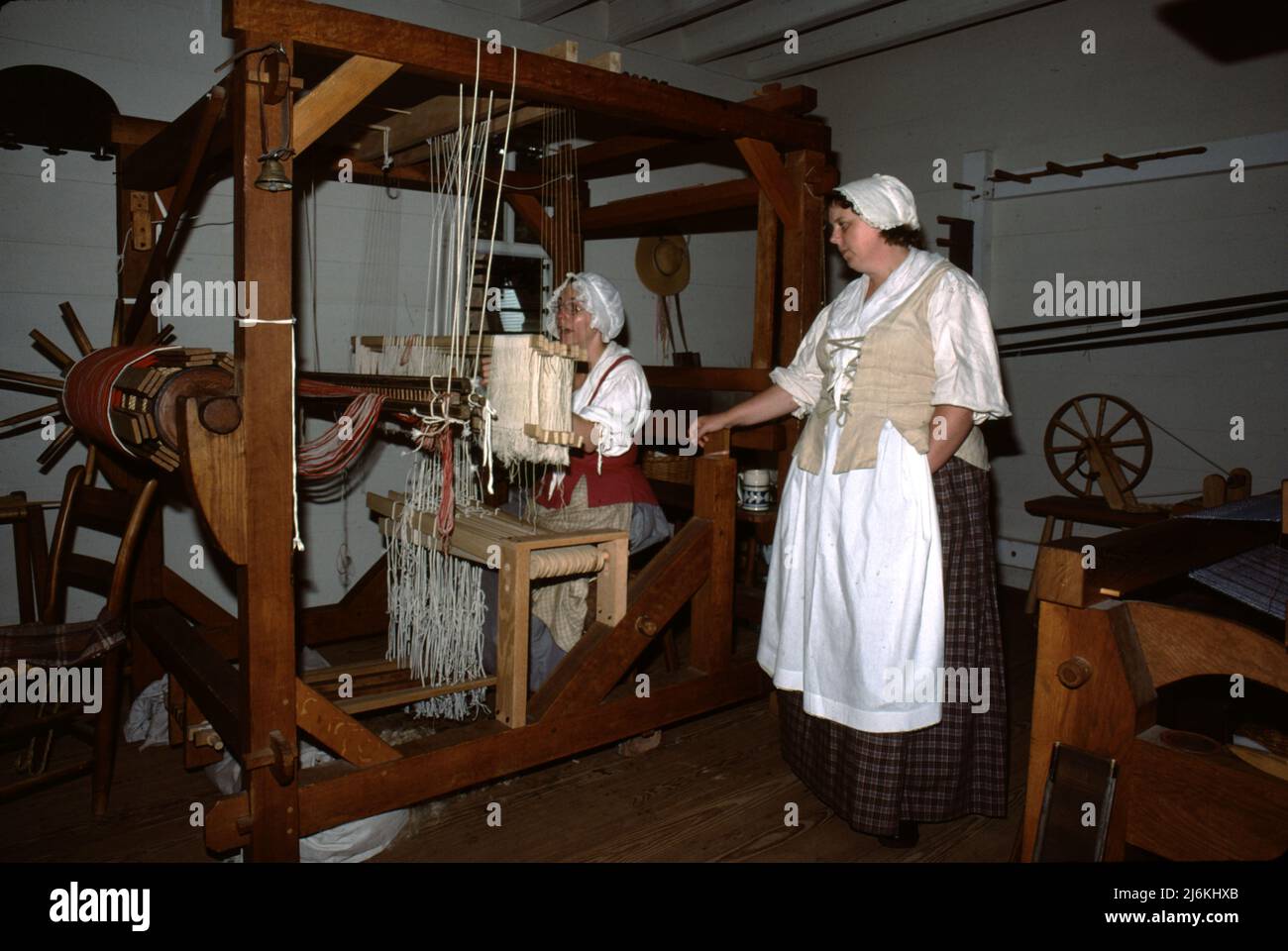 Williamsburg, VA. U.S.A. 9/1987. Colonial loom and spinning wheel ...