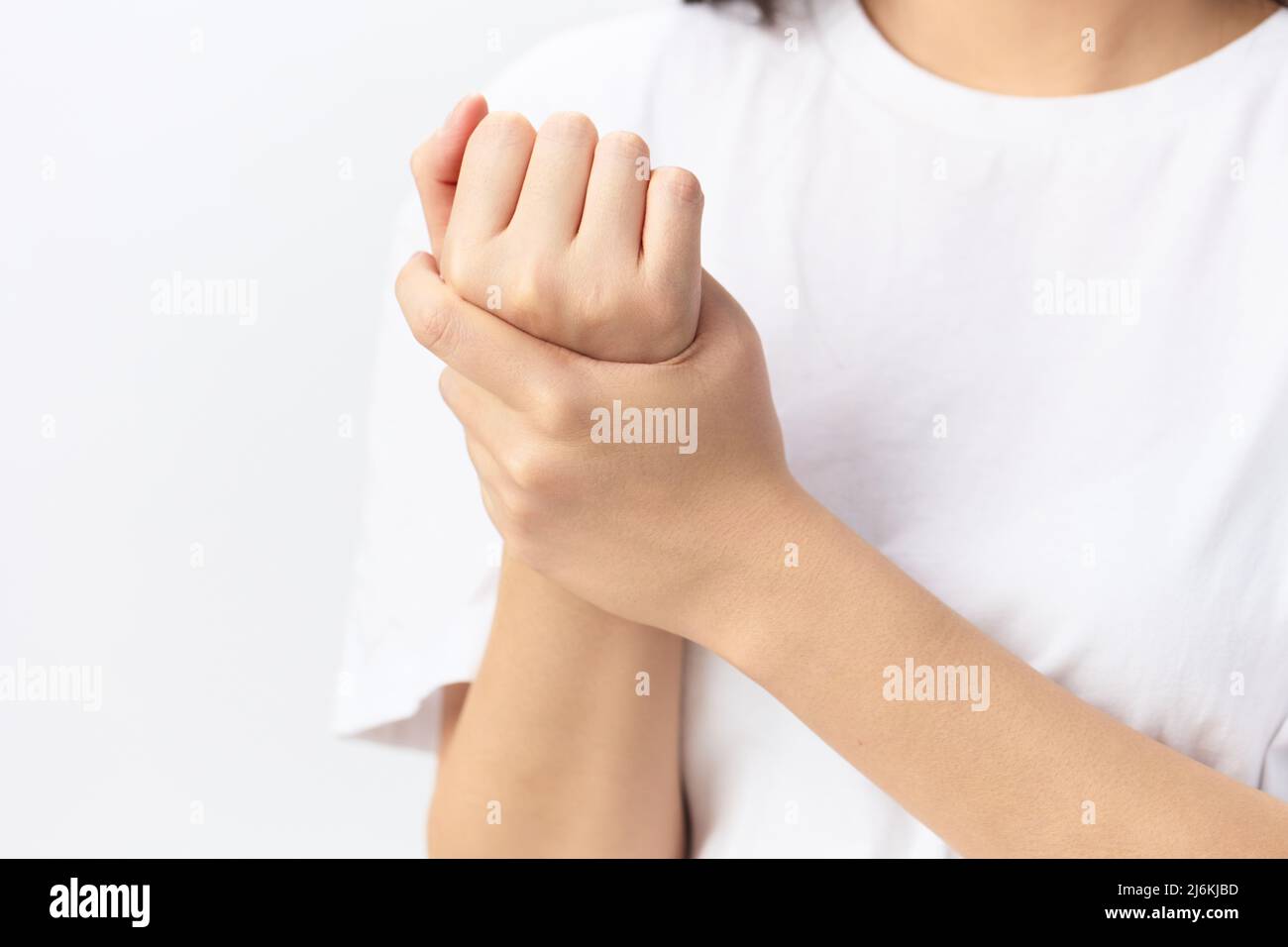 Broken hand Cramp. Closeup shot of suffering beautiful young Asian ...