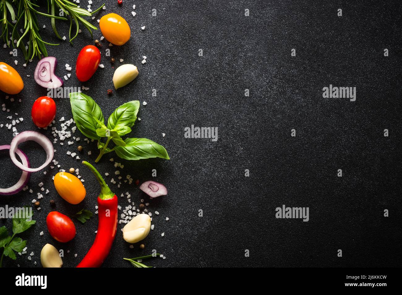 Food cooking background on black stone table Stock Photo - Alamy
