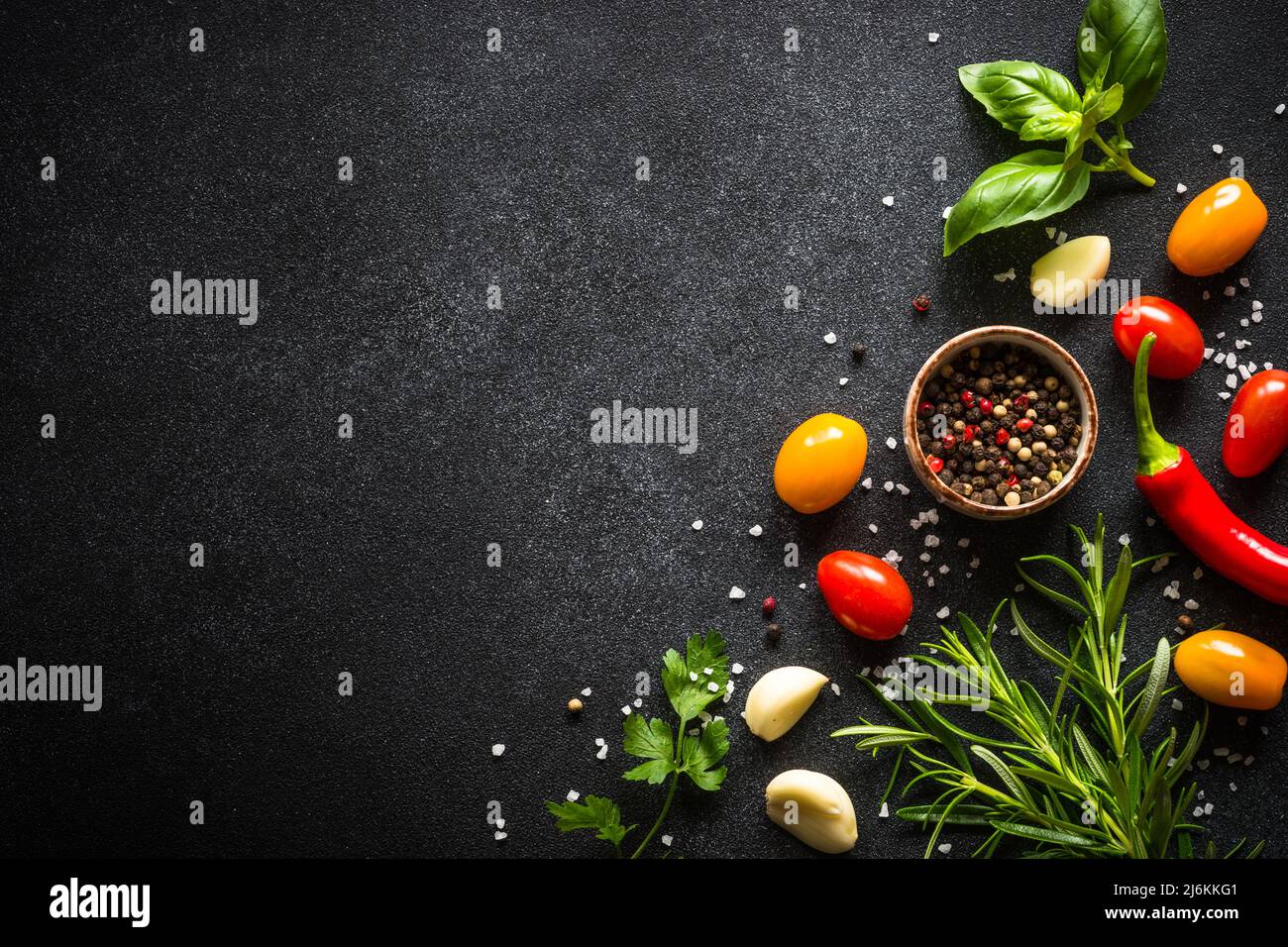 Food cooking background on black stone table Stock Photo - Alamy