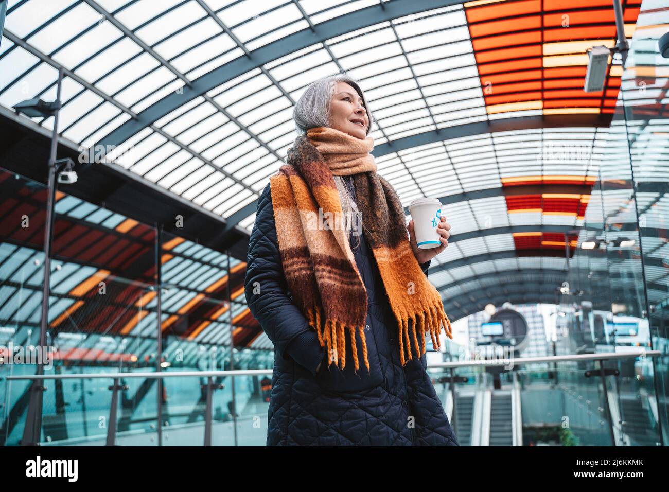 Senior woman waits for the train at the station Stock Photo - Alamy