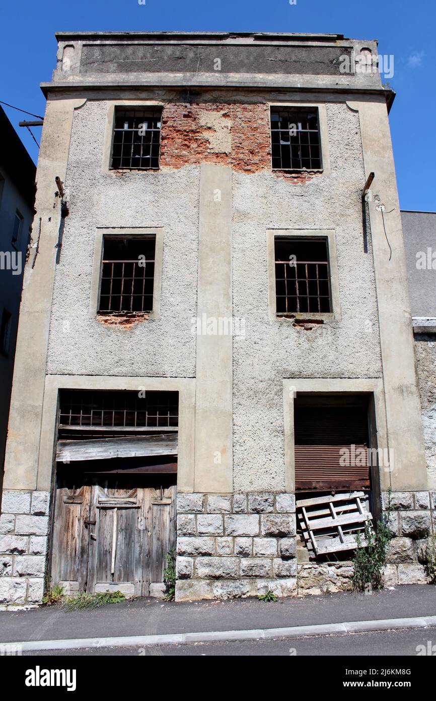 Narrow abandoned very old red bricks industrial building on traditional ...