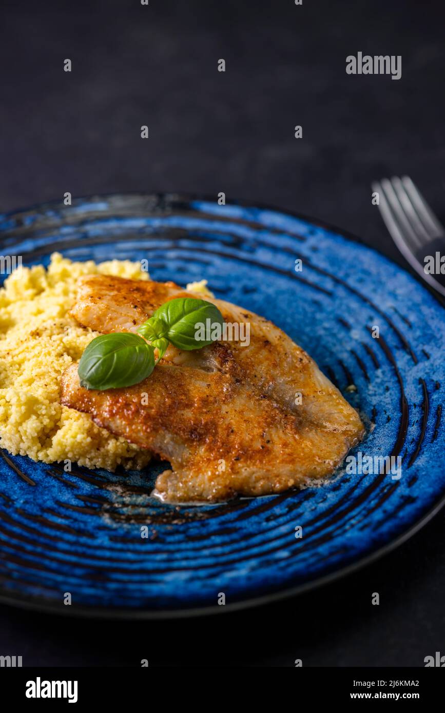spicy fillet of white cod with couscous Stock Photo - Alamy