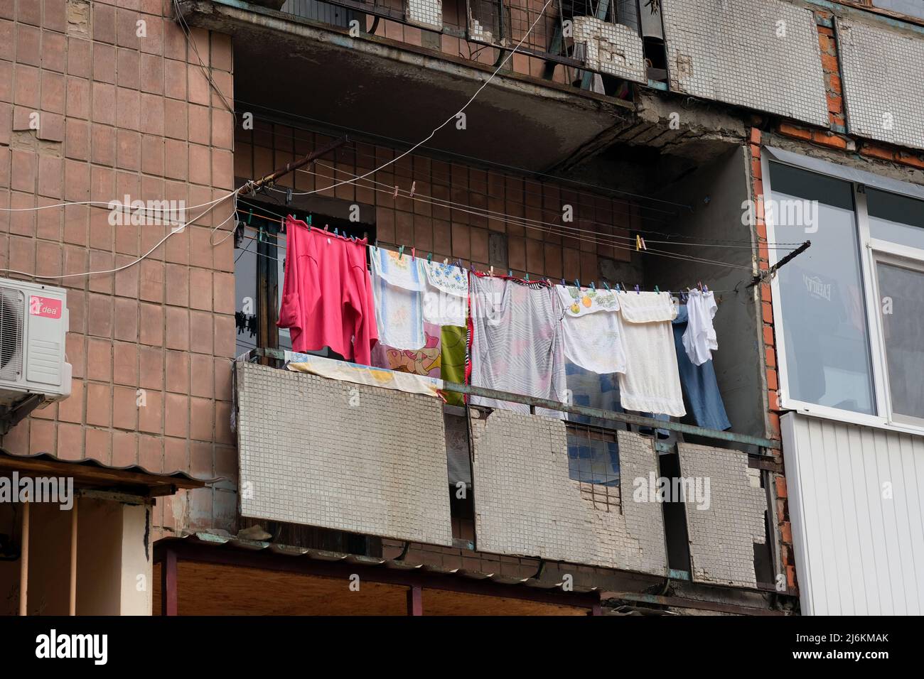 Laundry on the clothesline is dried on the old broken balcony. The ...