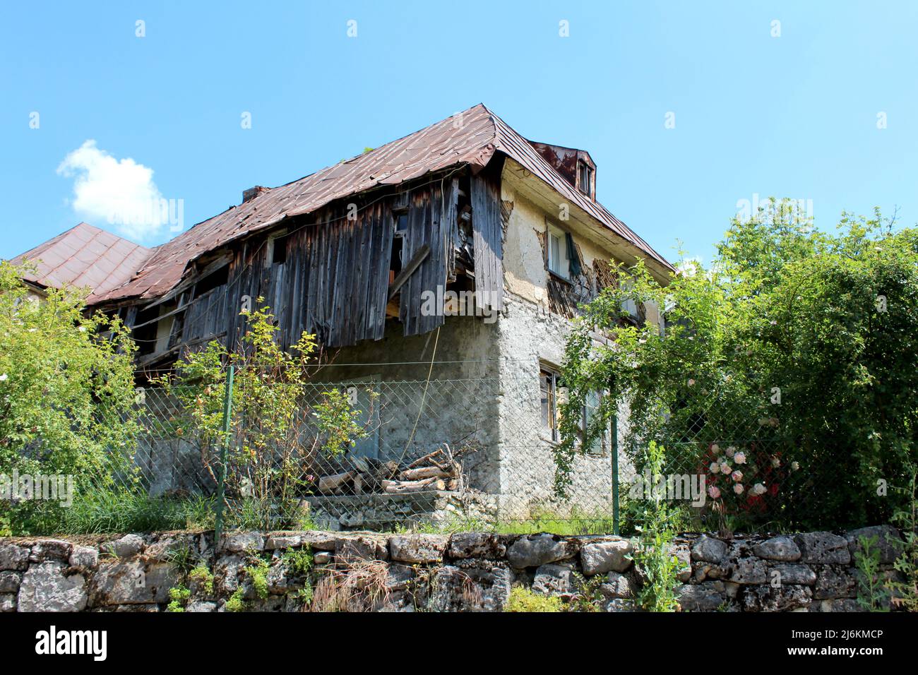 Very old abandoned dilapidated cracked wooden boards suburban family house built on concrete and ...