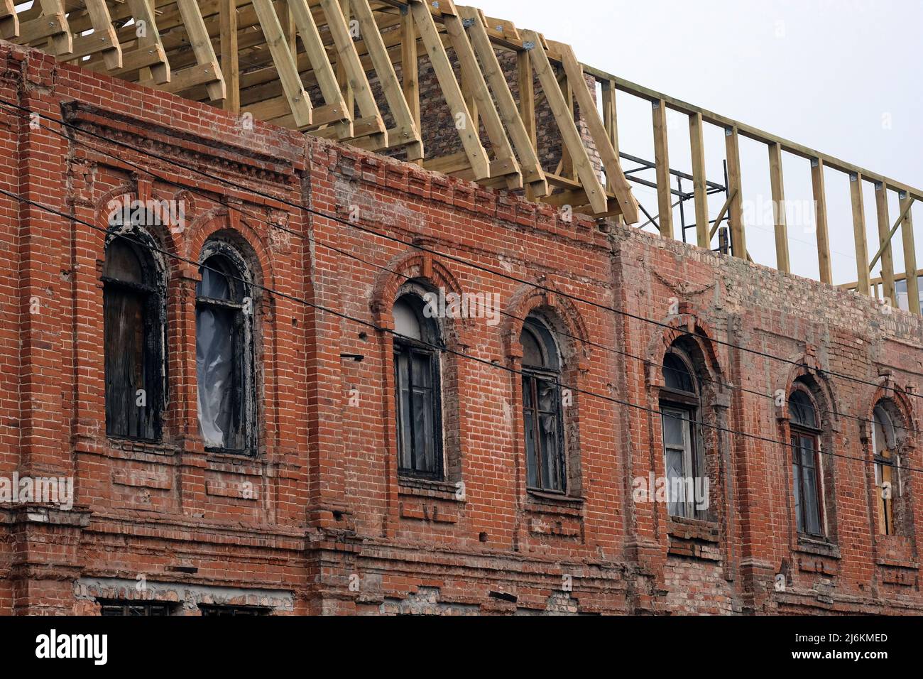 reconstruction of the building after a fire. red brick building with ...