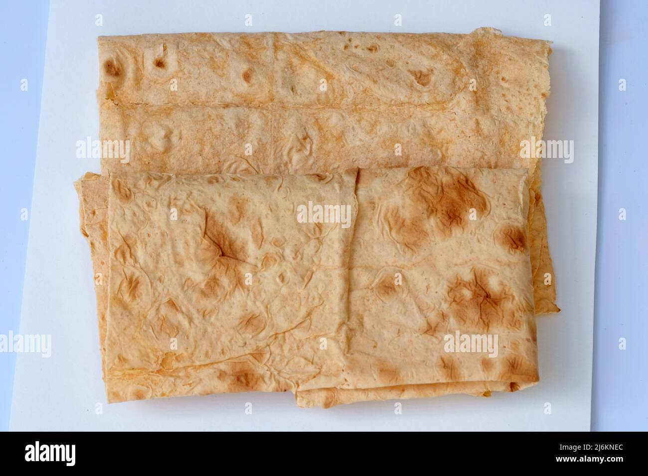Thin folded Armenian lavash with paprika view from above. Thin lavash ...