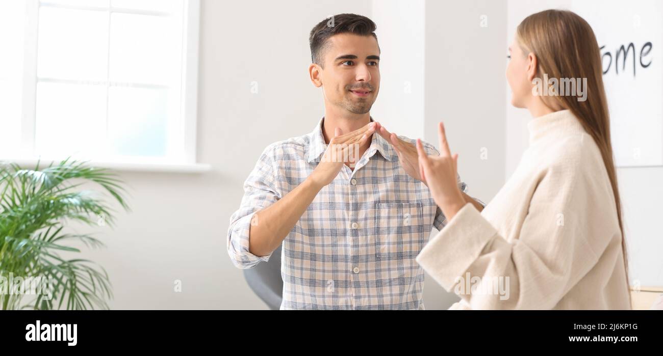 Young deaf mute couple using sign language at home Stock Photo - Alamy