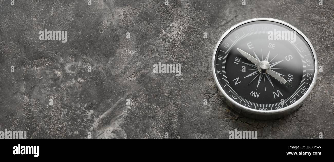 Compass on grey background with space for text Stock Photo - Alamy