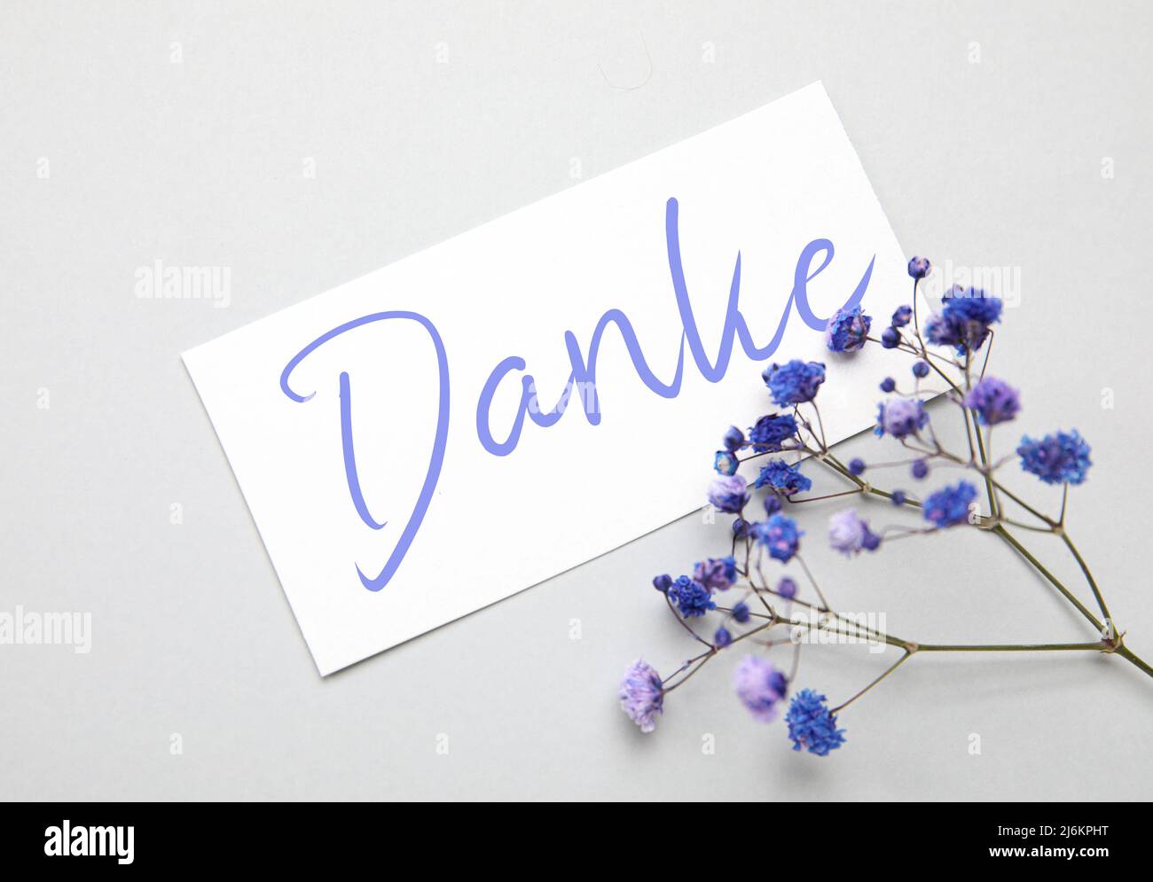 Card with word DANKE (German for Thanks) and flowers on light ...