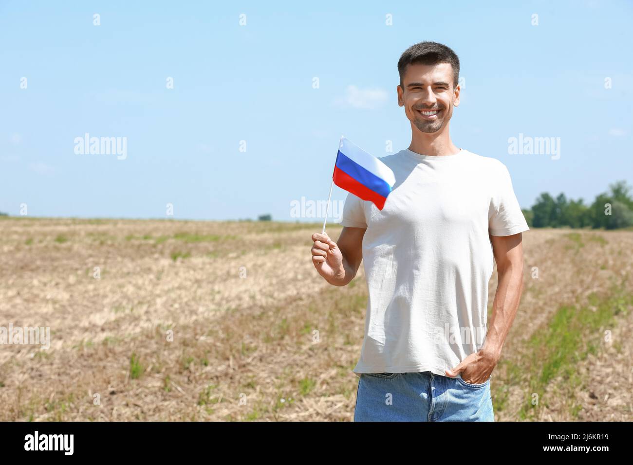Young man with national flag of Russia outdoors Stock Photo - Alamy